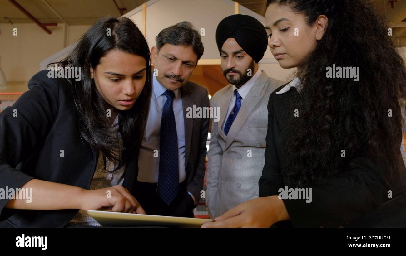 Group of Indian co-workers brainstorming during a business meeting ...