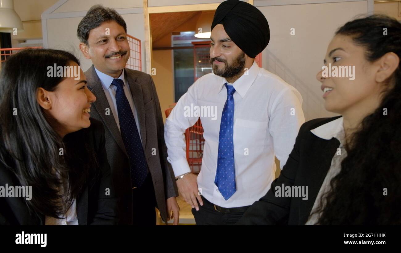 Group of Indian co-workers talking during the break Stock Photo - Alamy
