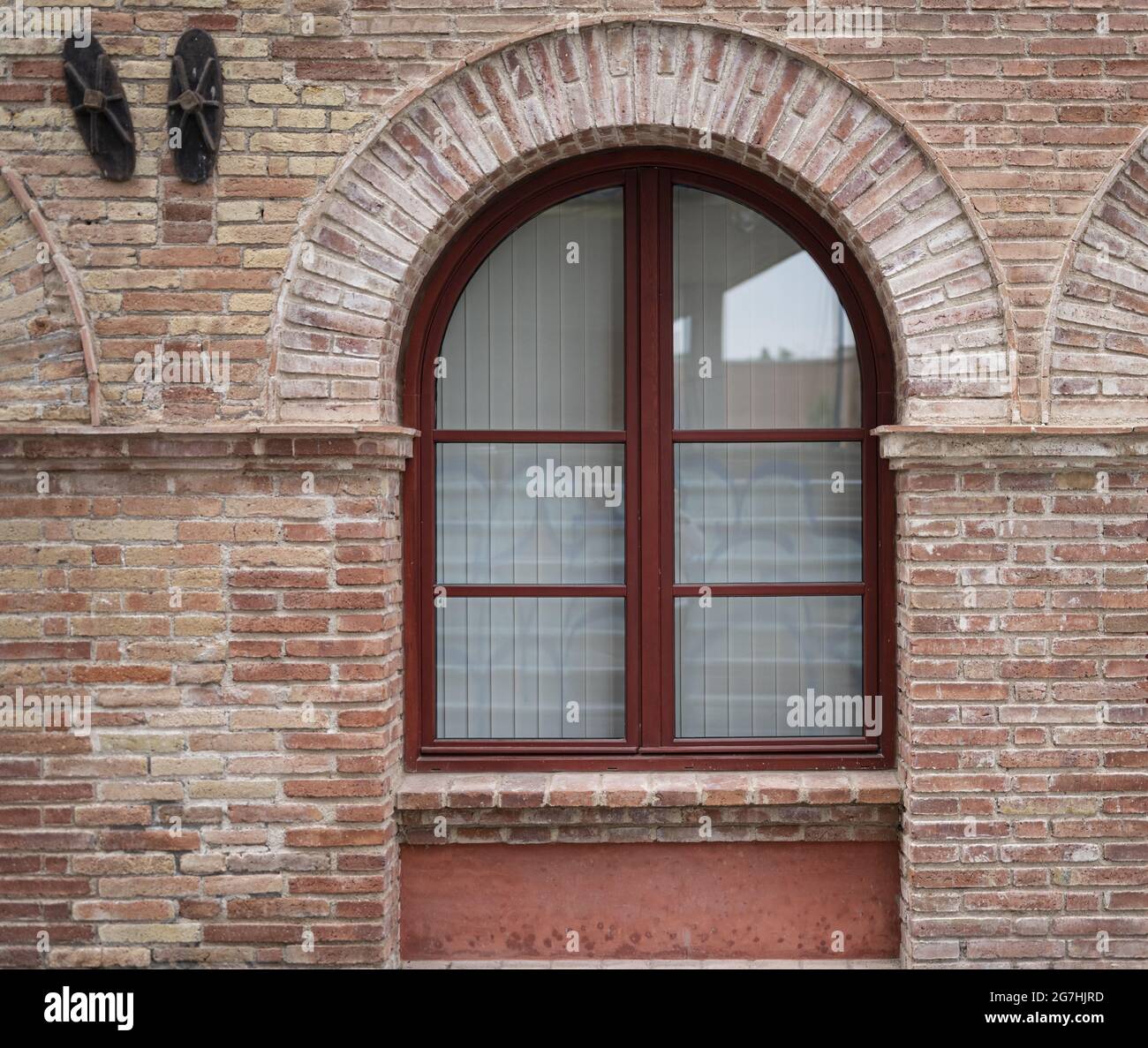 Closeup of a window with blinds of a brick building in the daylight ...