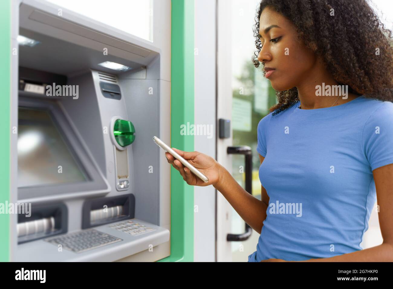 Portrait of young afro woman using credit card Stock Photo - Alamy