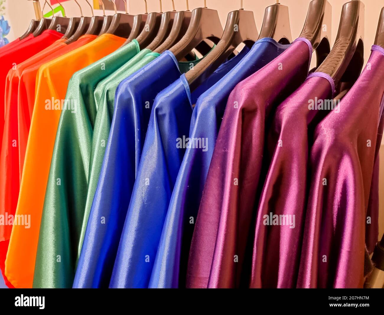Rainbow colors. Choice of casual clothes on black hangers, isolated on ...
