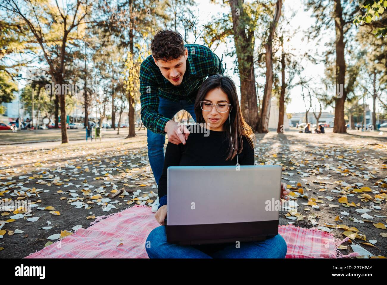 young couple using computer outdoors Stock Photo - Alamy