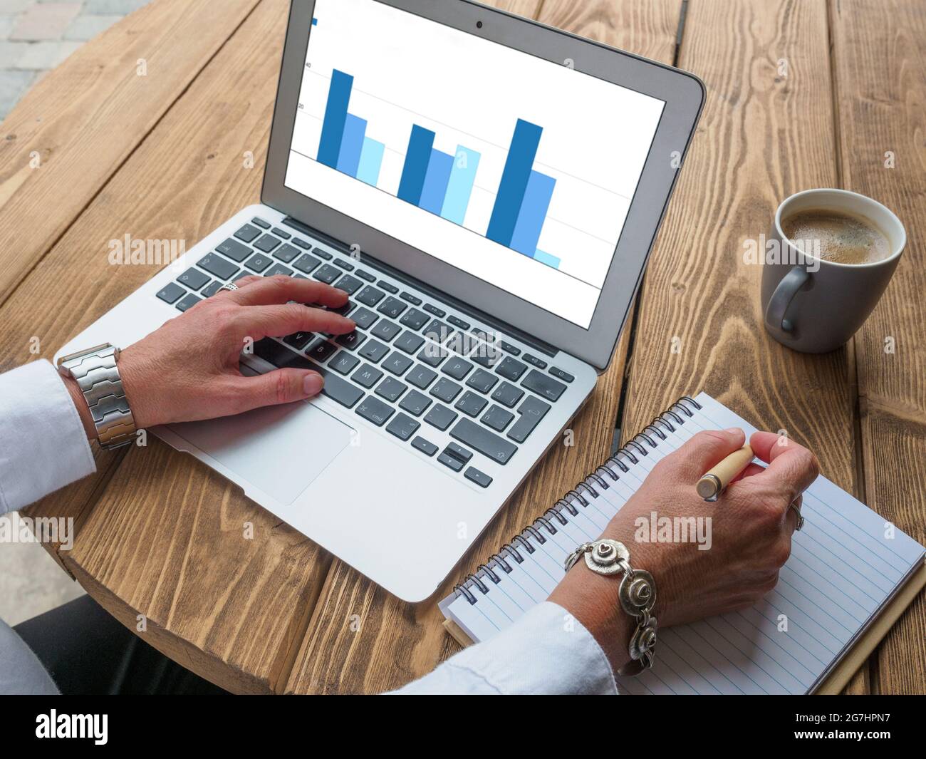 Businesswoman hands work on laptop with statistics chart on screen ...