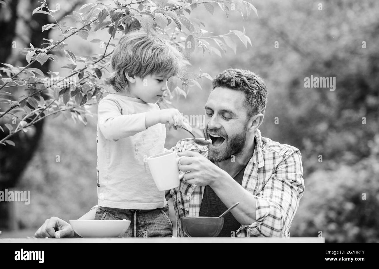 Family enjoy homemade meal. Food habits. Little boy with dad eating ...