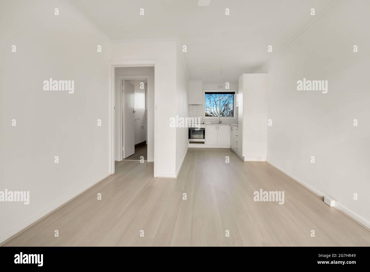 Empty living room with a small kitchen and bathroom. Empty apartment ...