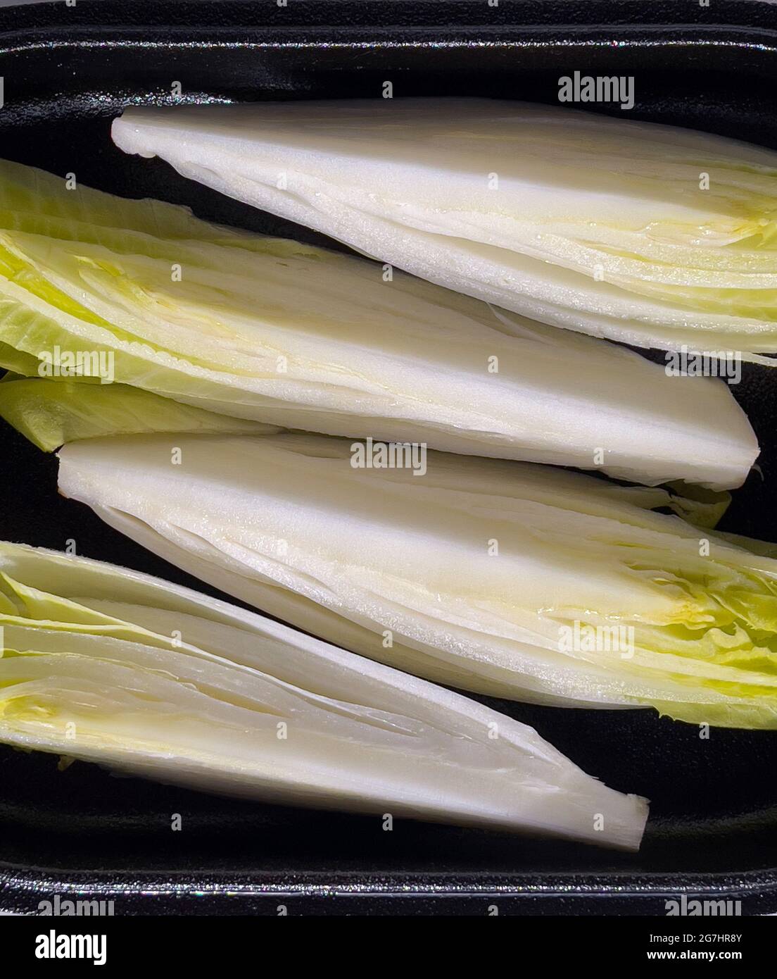 chicory in cast iron roasting dish Stock Photo - Alamy