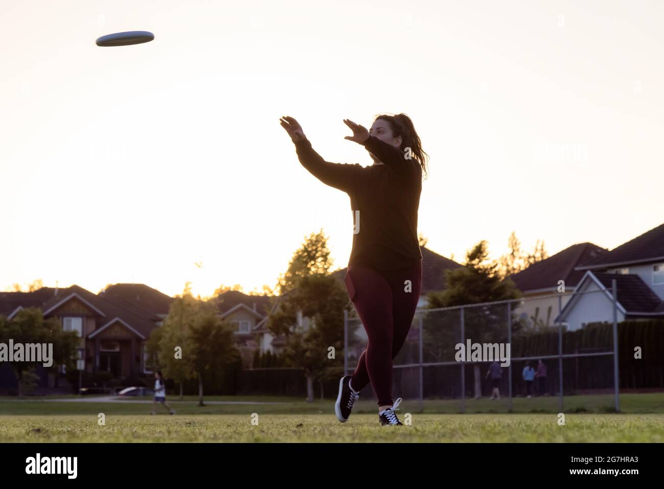 White Caucasian Adult Girl Playing Frisbee in the Green Field Stock ...