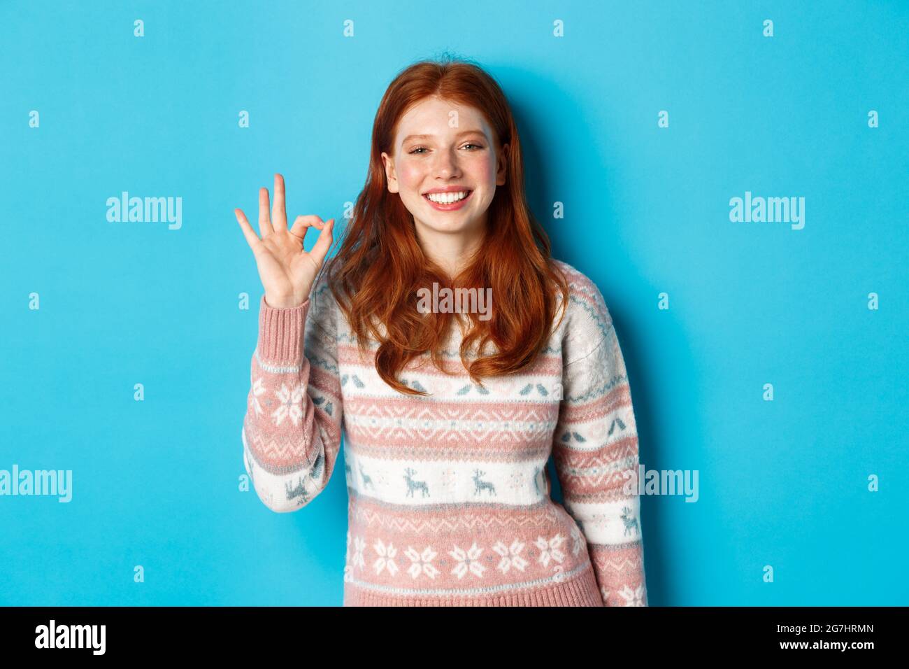 Cute smiling redhead woman showing okay sign, praising good work, well ...
