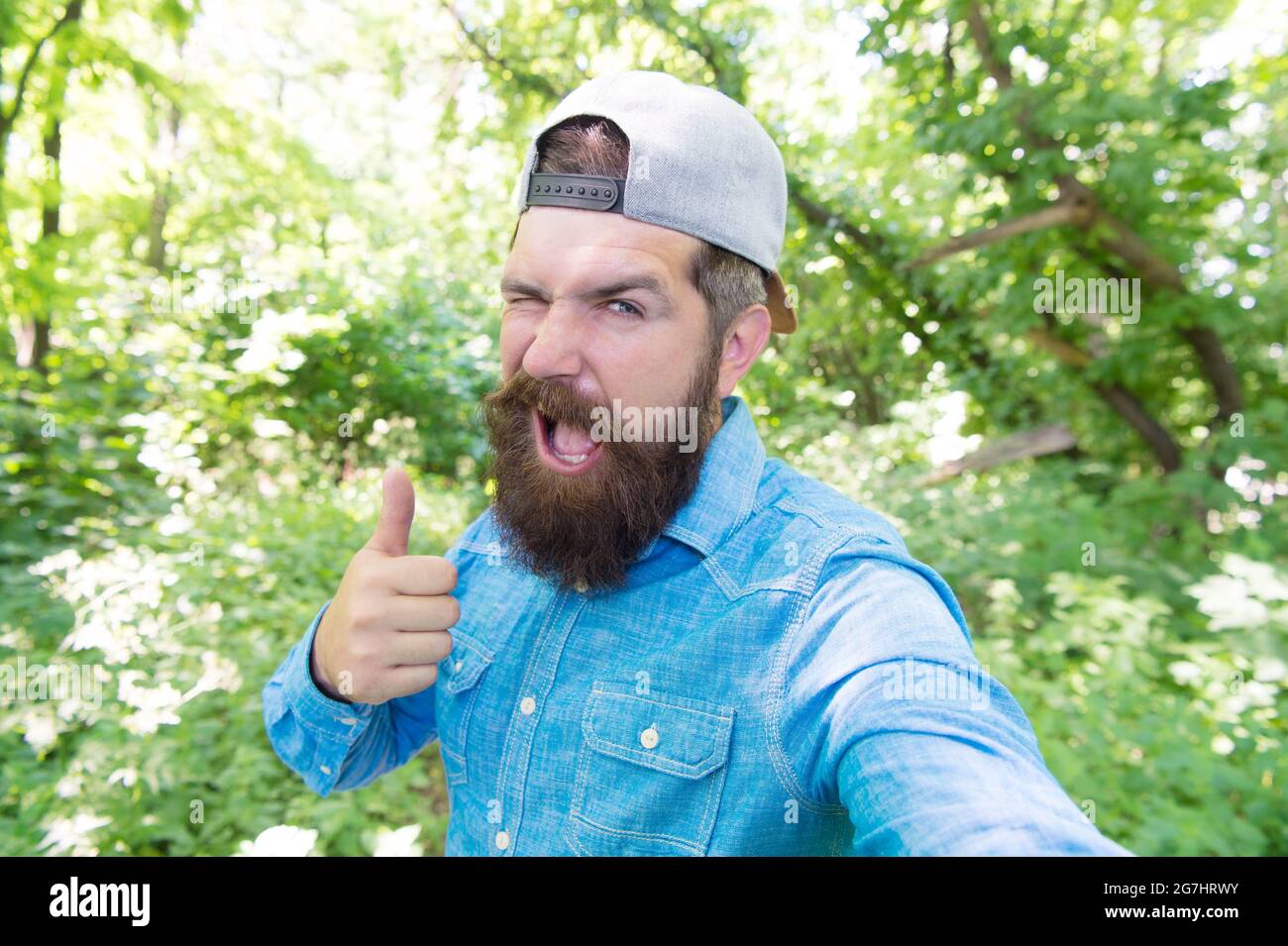 happy mature bearded man with beard make selfie photo in summer forest ...