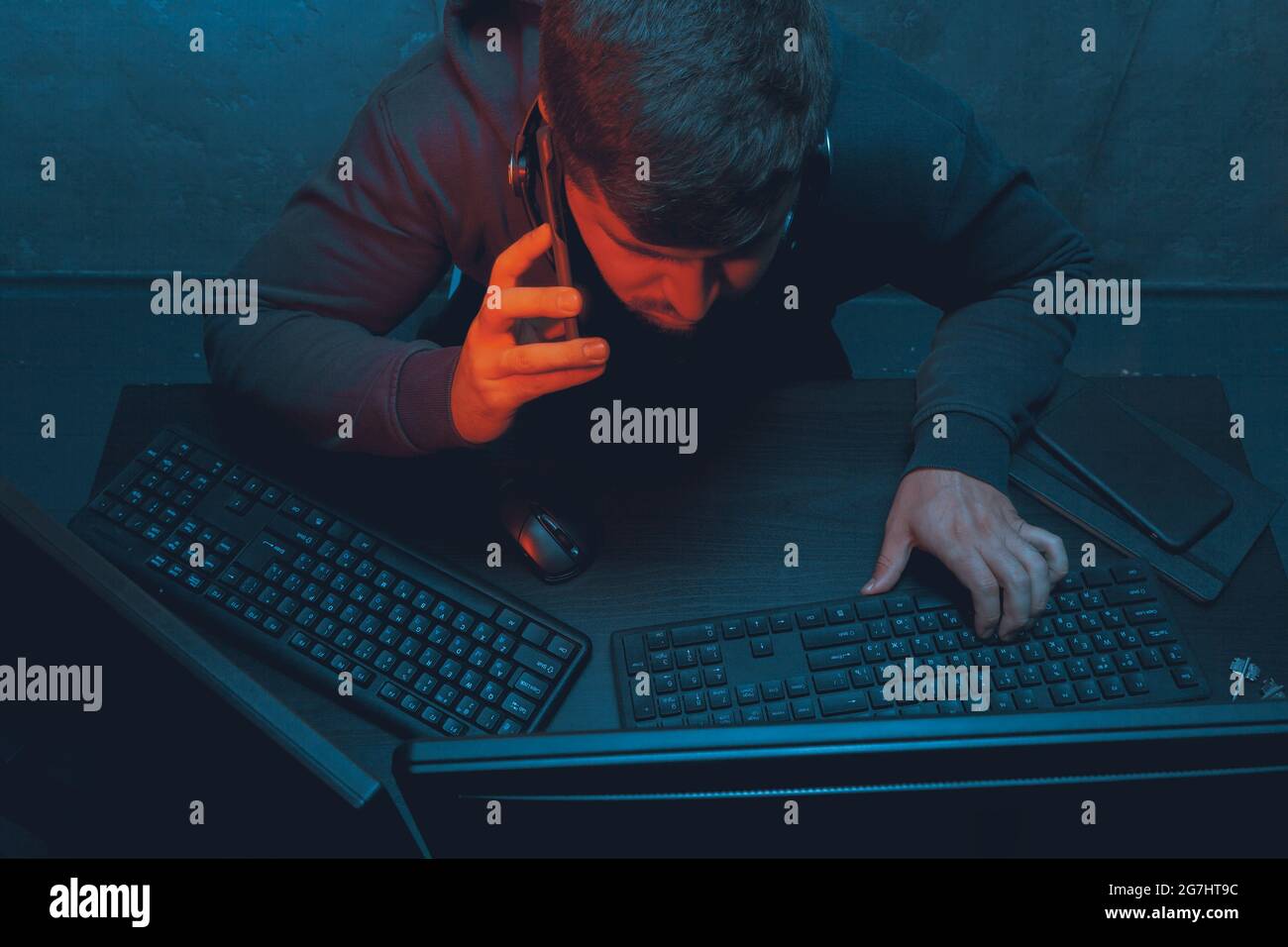 Hacker programmer using computer in dark room Stock Photo - Alamy