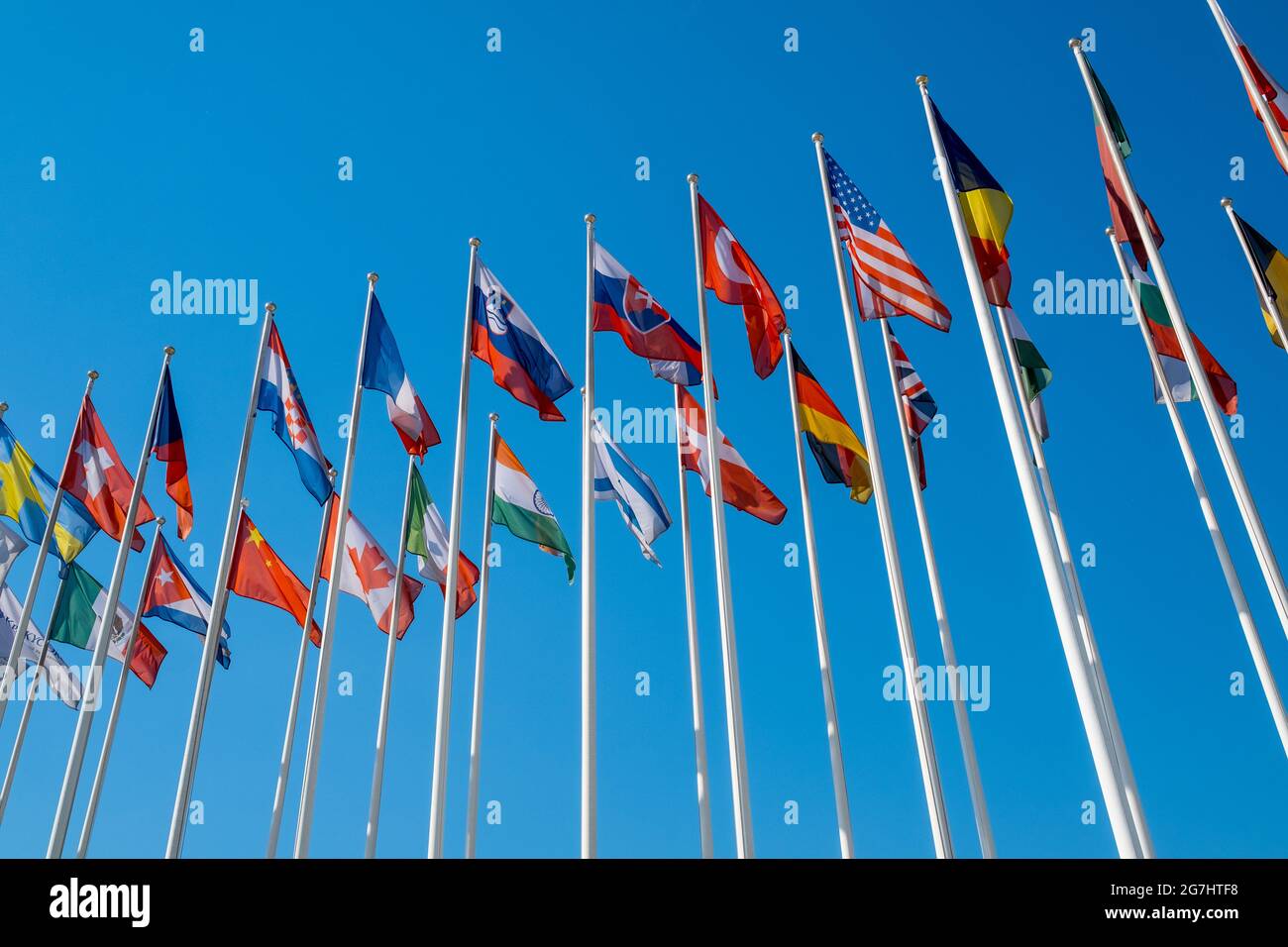 Different flags fluttering on flagpoles Stock Photo - Alamy