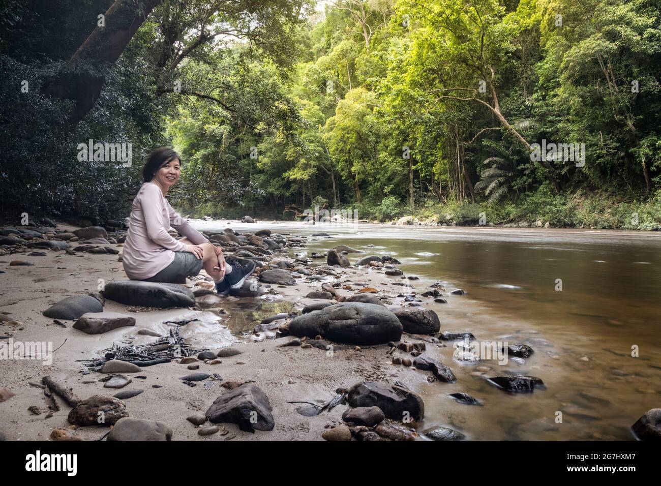 Tourist admiring scenic nature view of Tahan River bank with lush ...