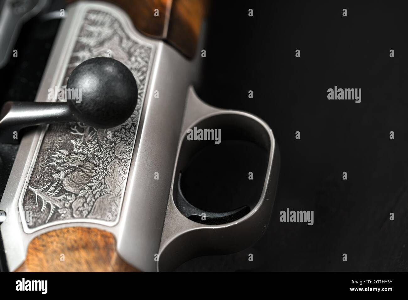 Metal trigger on hunting gun on black background Stock Photo - Alamy