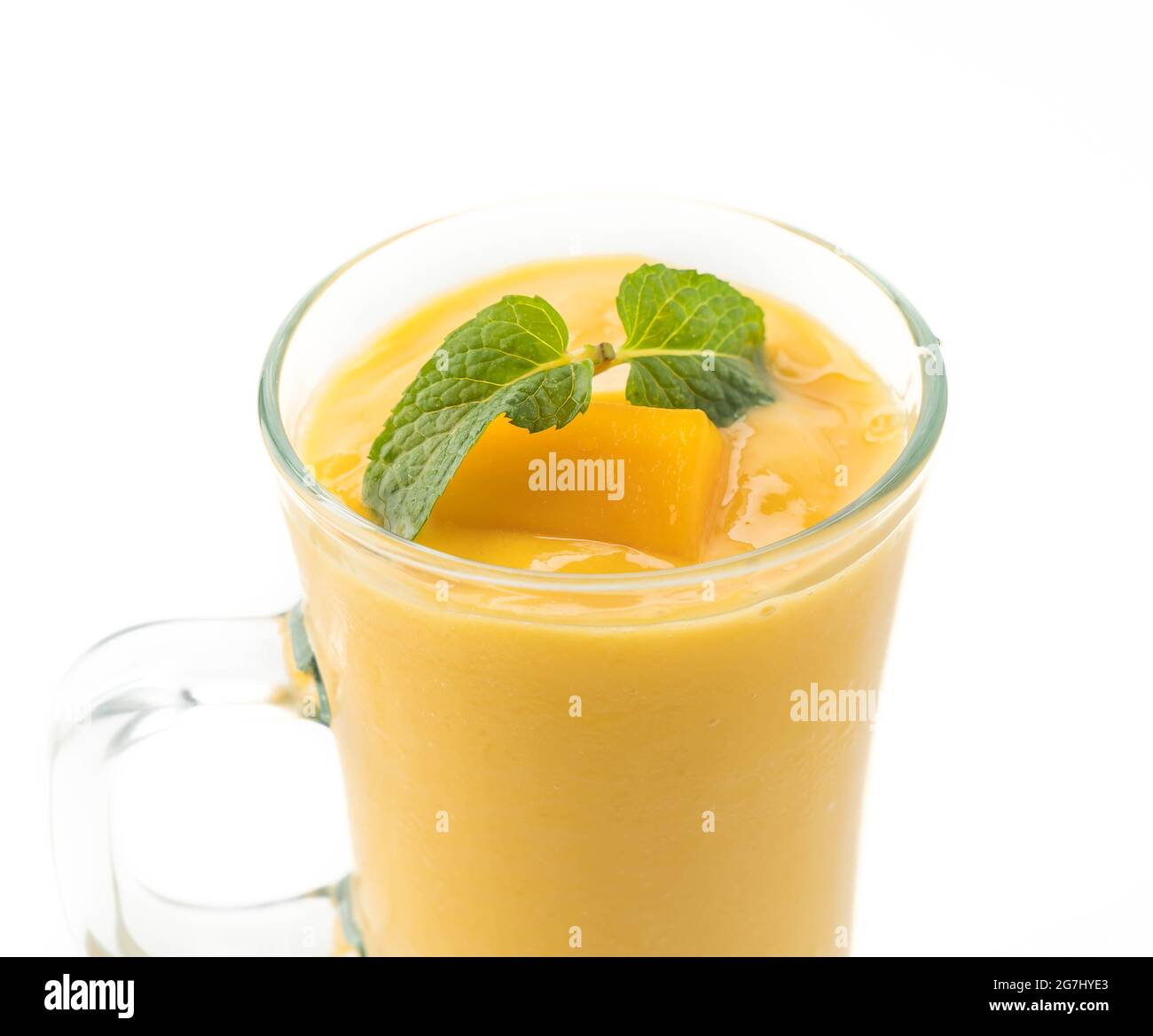 fresh mango smoothie on white background Stock Photo - Alamy