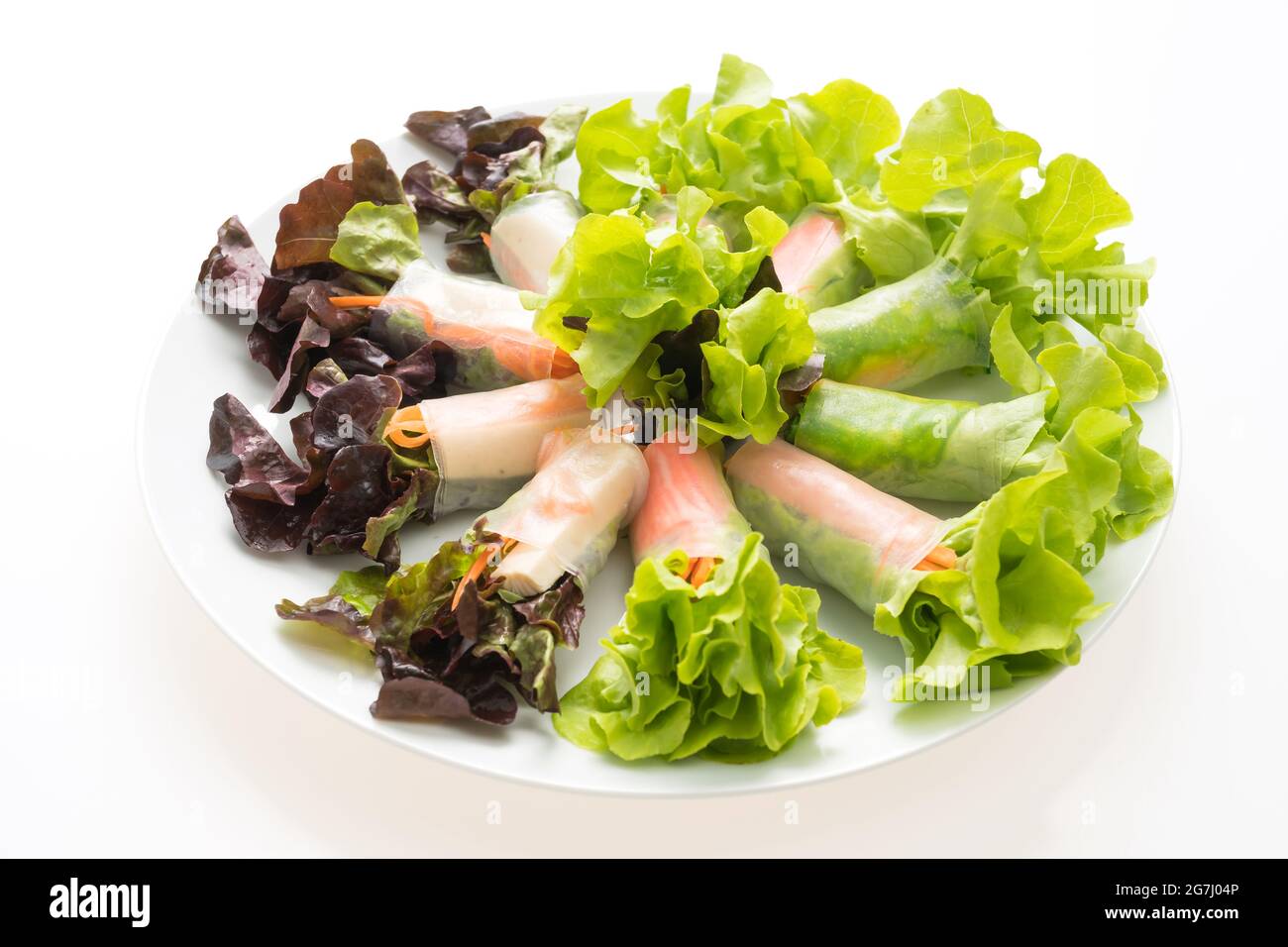 Vegetable spring roll in white plate isolated on white background ...