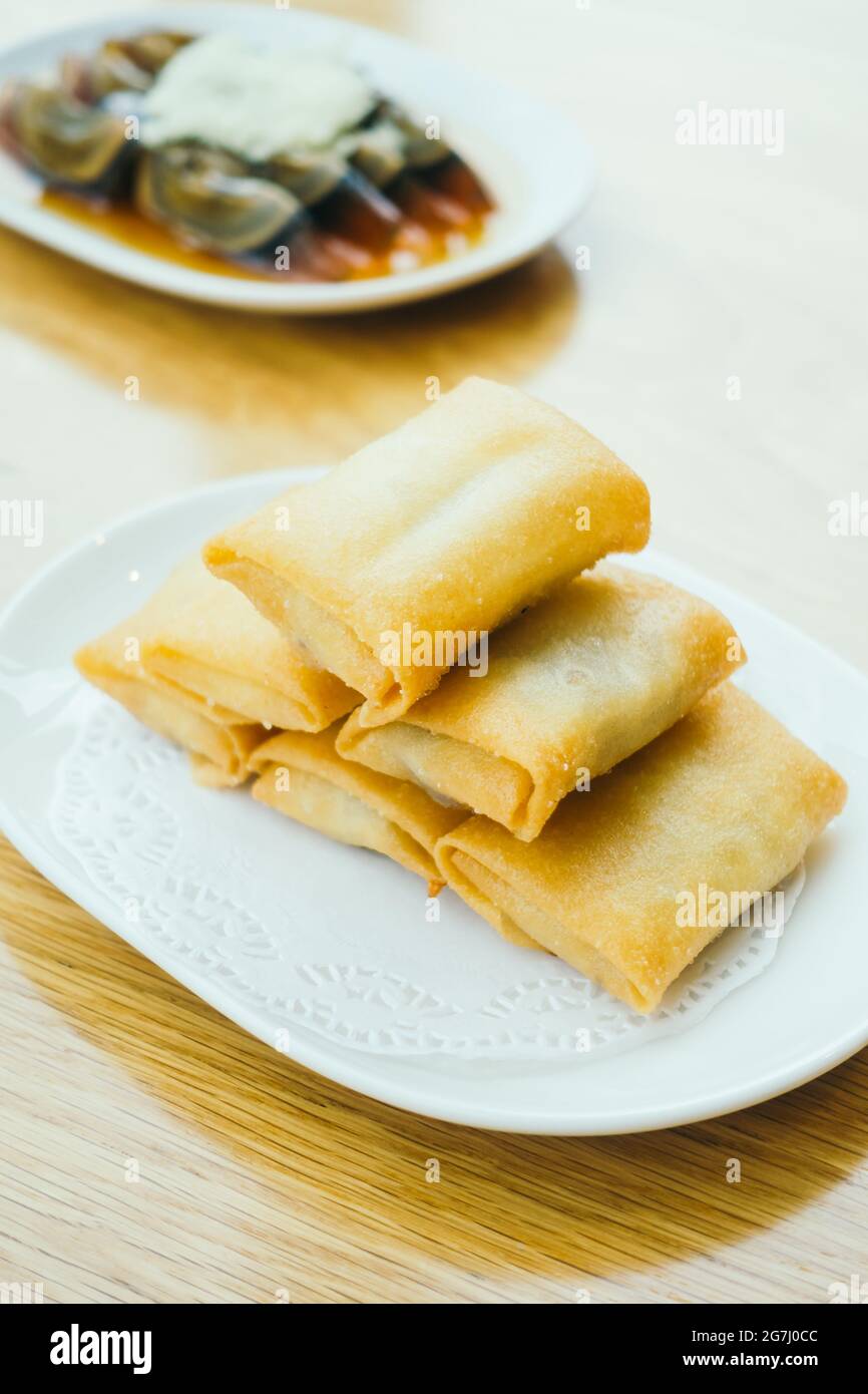 Fried spring roll in white plate - Chinese food style Stock Photo - Alamy