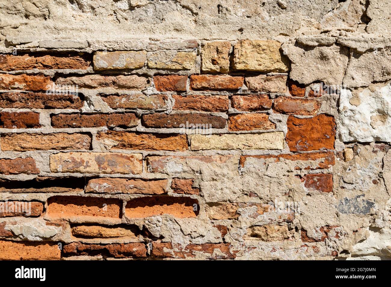 old brick and stucco wall, with deteriorating brick and mortar Stock ...