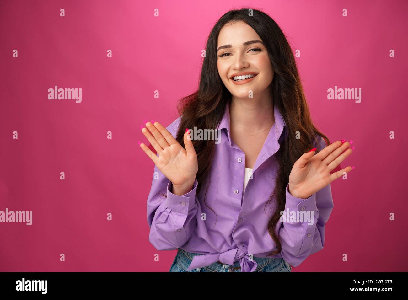 Young happy woman smiling over pink background Stock Photo - Alamy