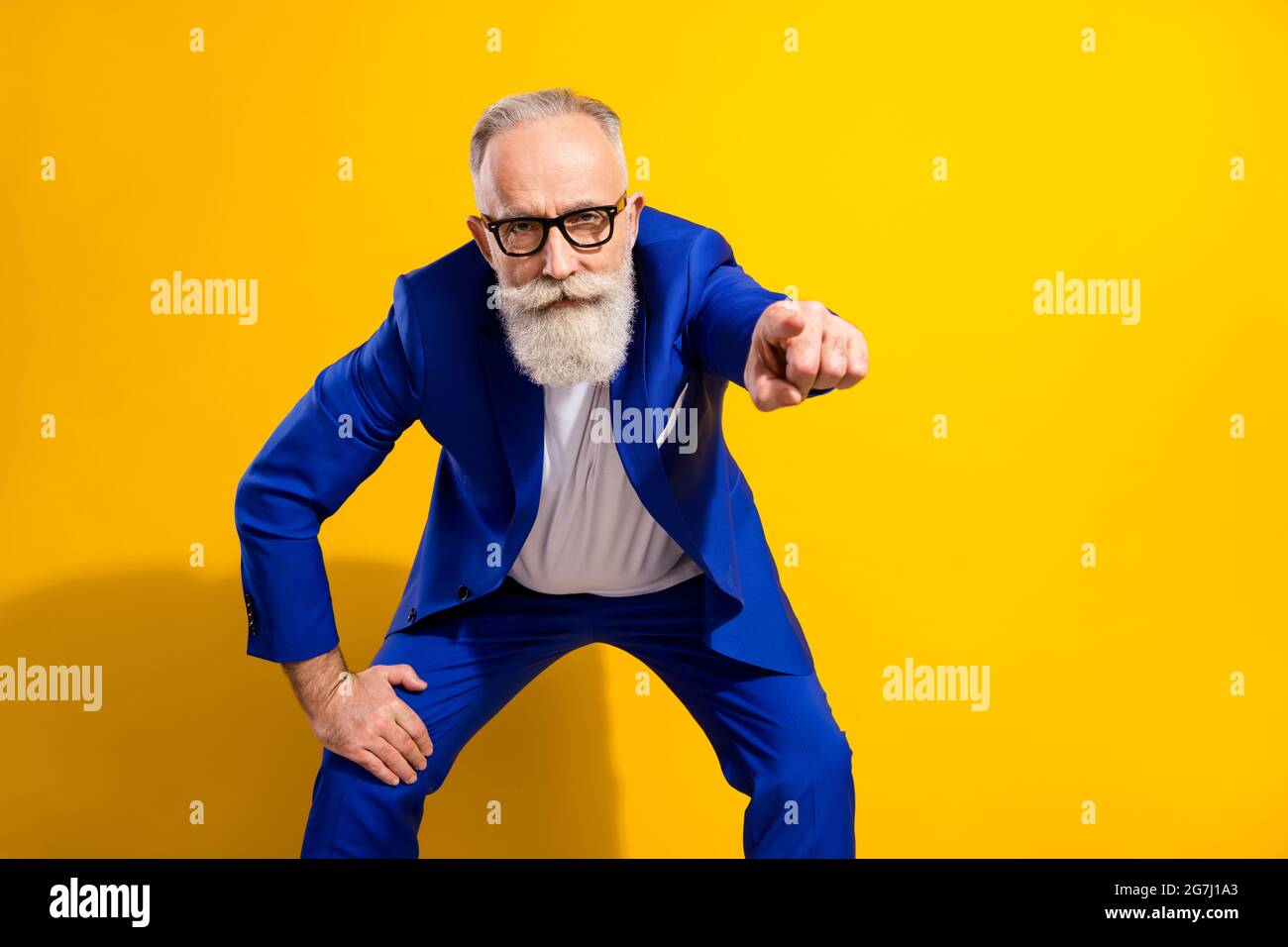 Photo portrait of businessman in blue suit spectacles serious pointing ...