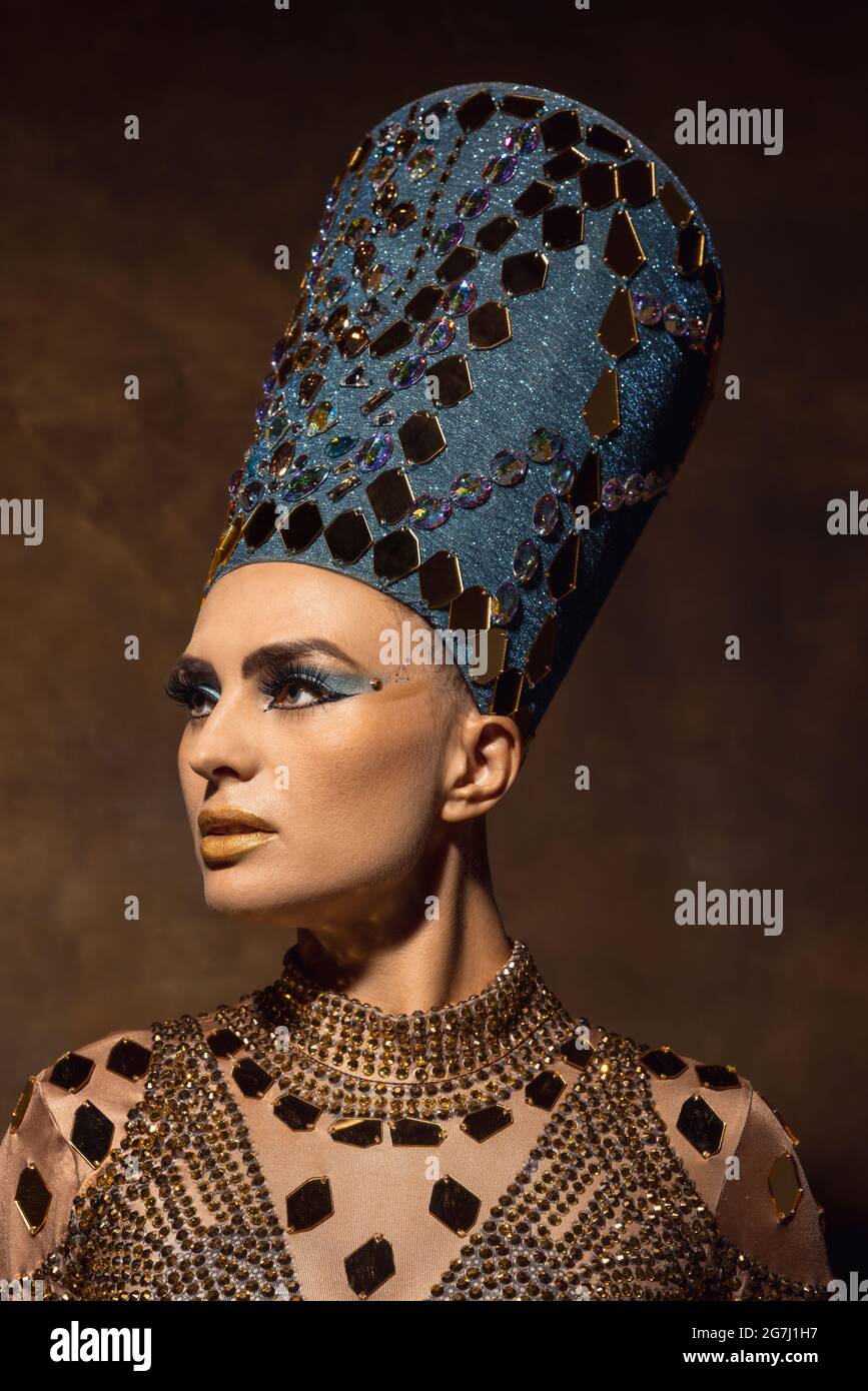 Close-up beautiful young woman in image of Nefertiti in art performance ...