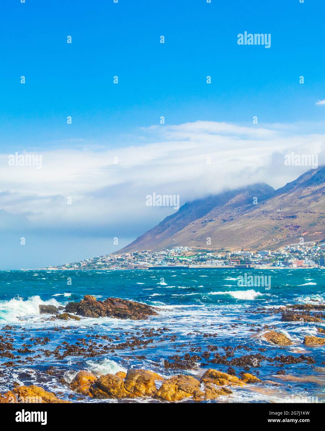 False Bay rough coast landscape with boulders waves and mountains with ...