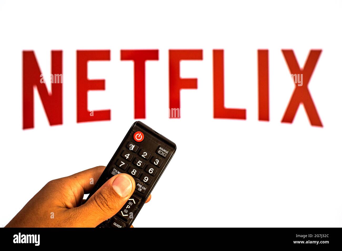 In this photo illustration a close-up of a hand holding a TV remote ...