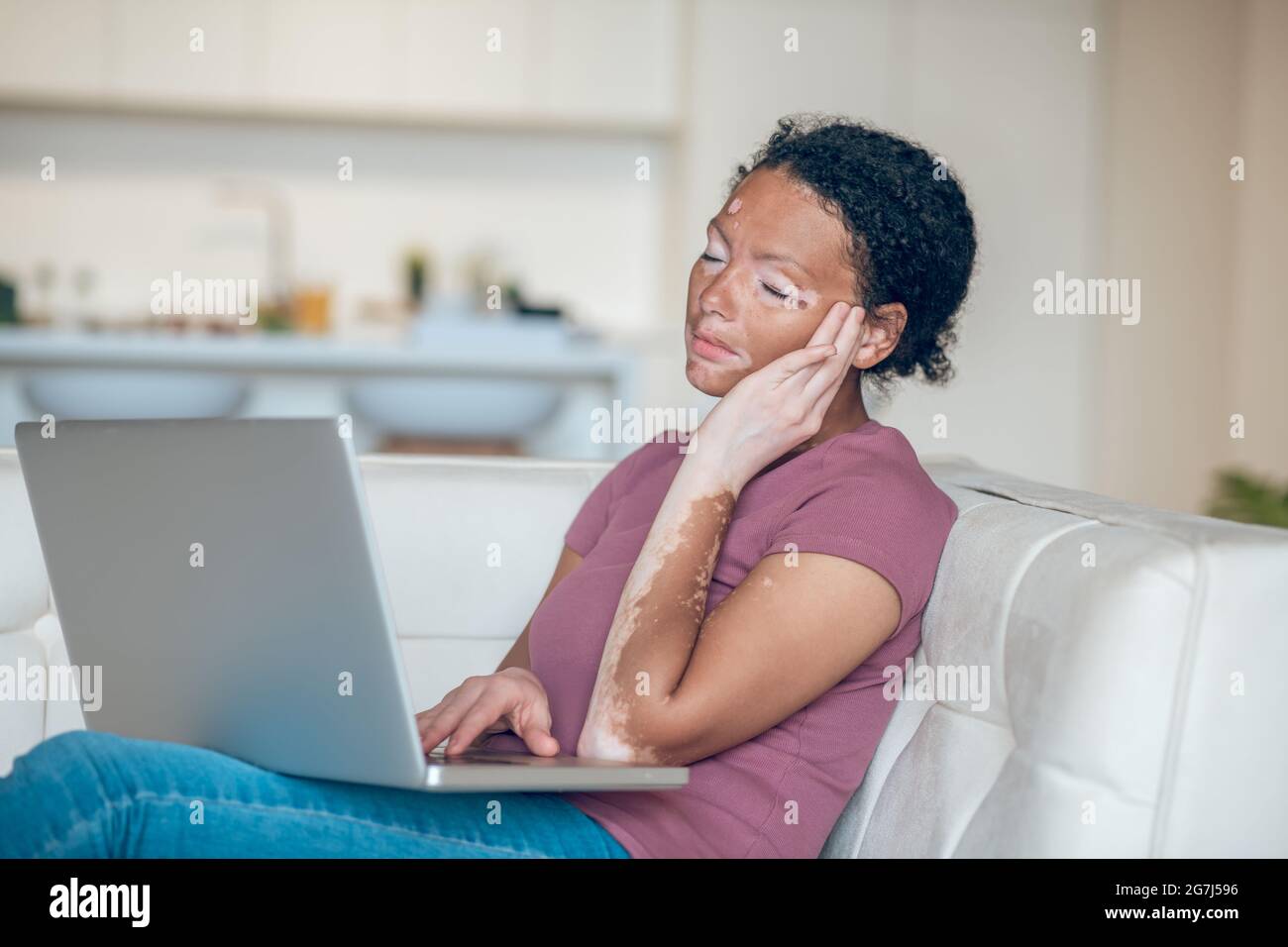 Cute young woman looking tired after a working day Stock Photo - Alamy