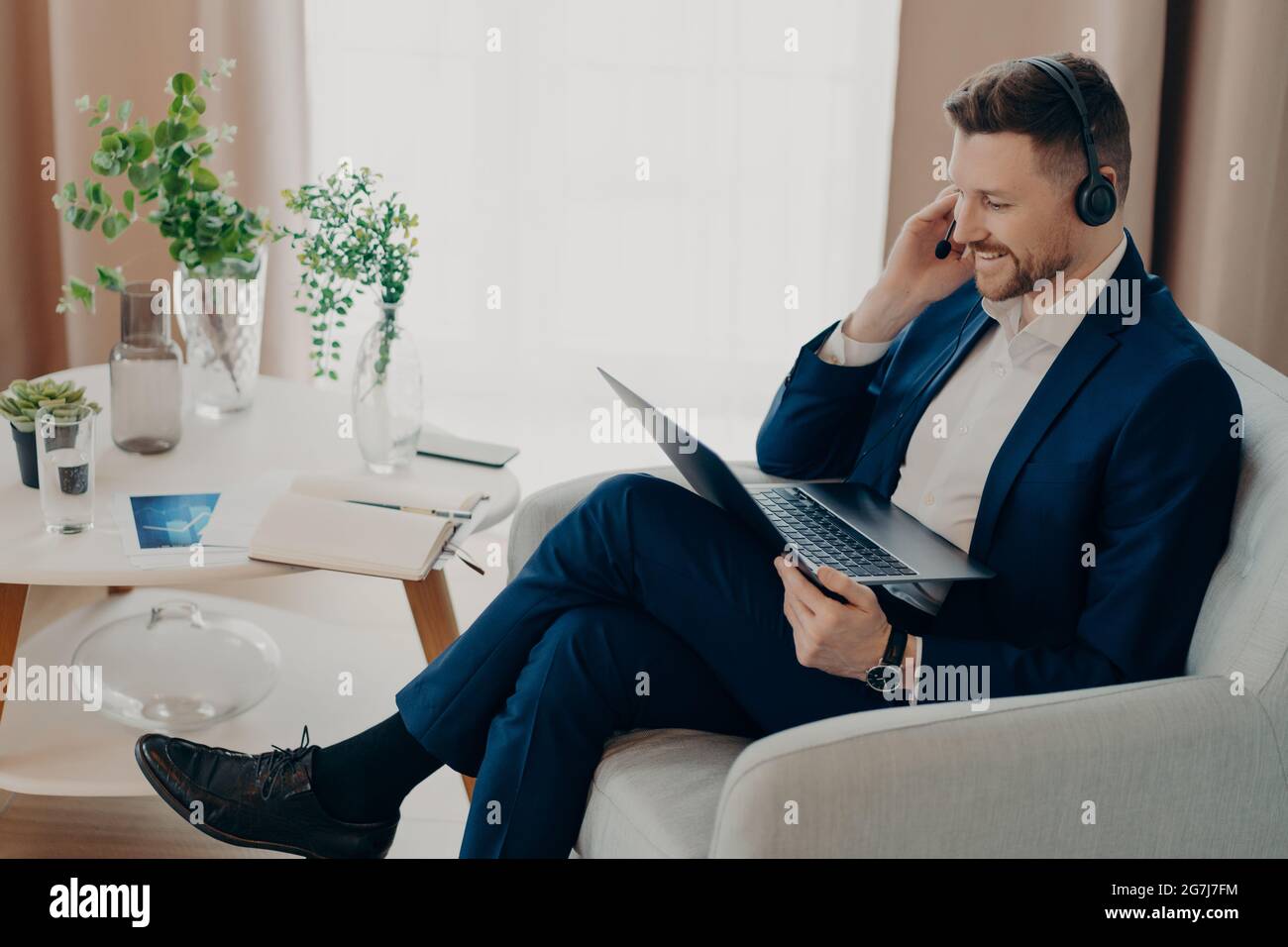 Prosperous bearded male corporate worker focused at laptop omputer ...