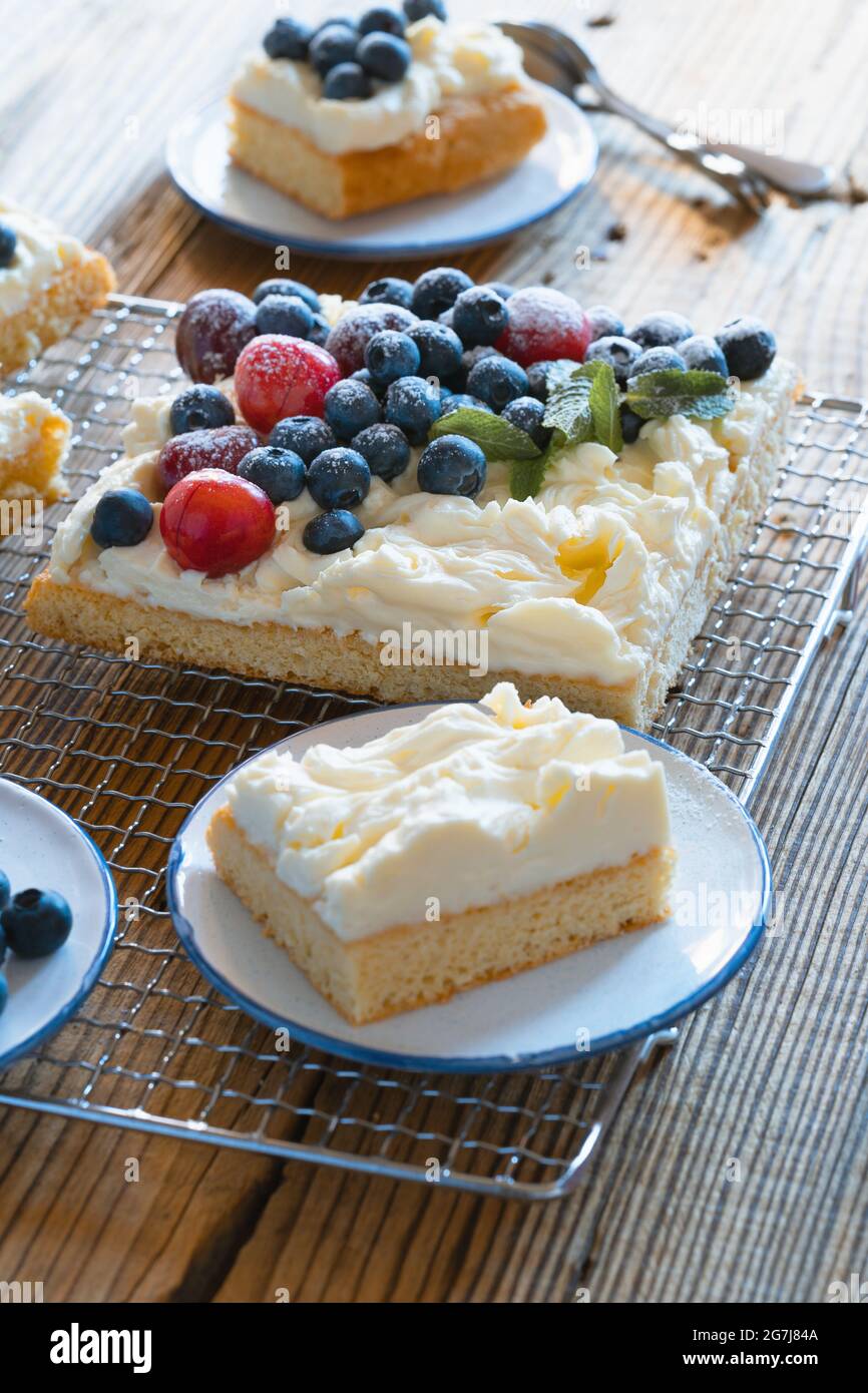 Sponge cake with fresh summer berries and cream top view, sliced Stock ...