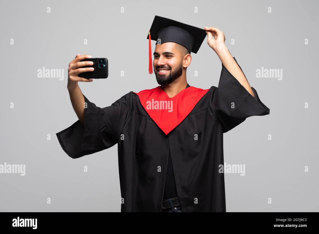 College graduate taking a selfie with cell phone holding a diploma ...