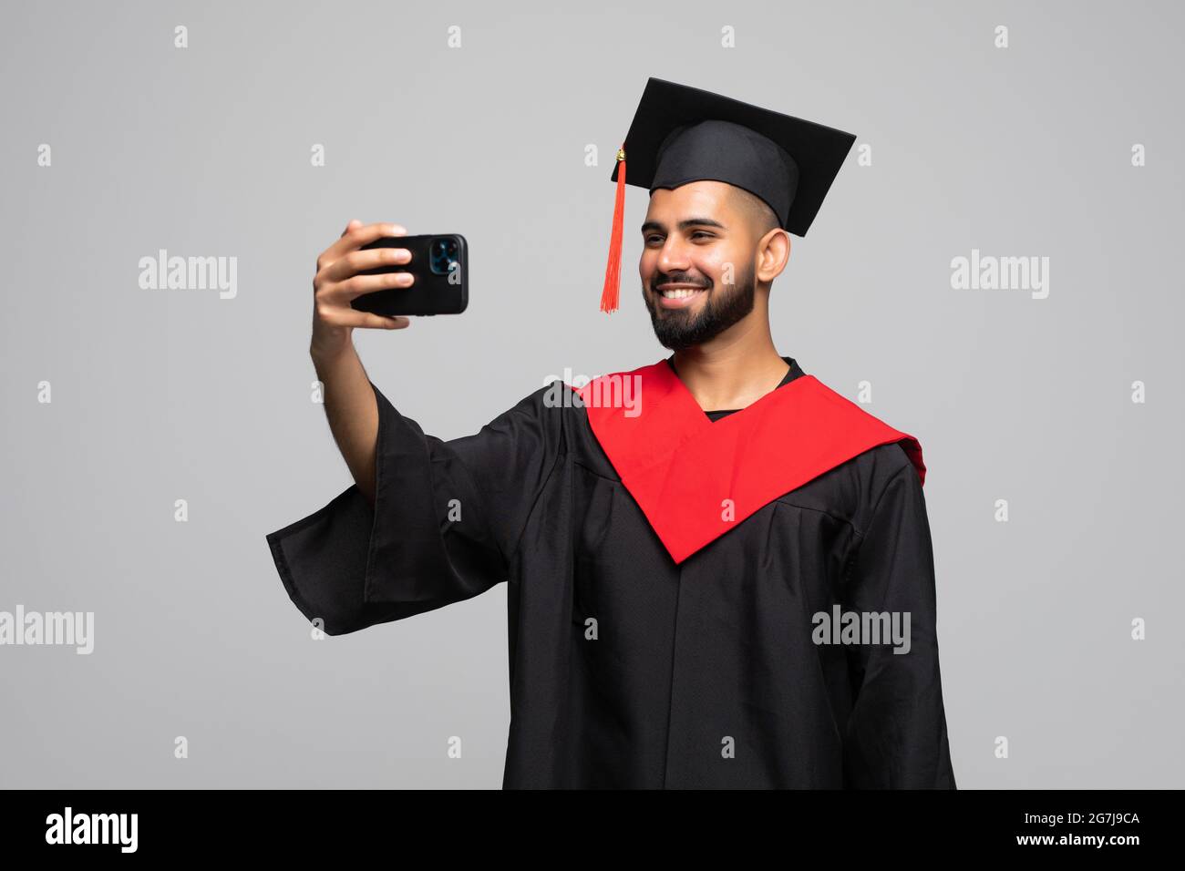 College graduate taking a selfie with cell phone holding a diploma ...