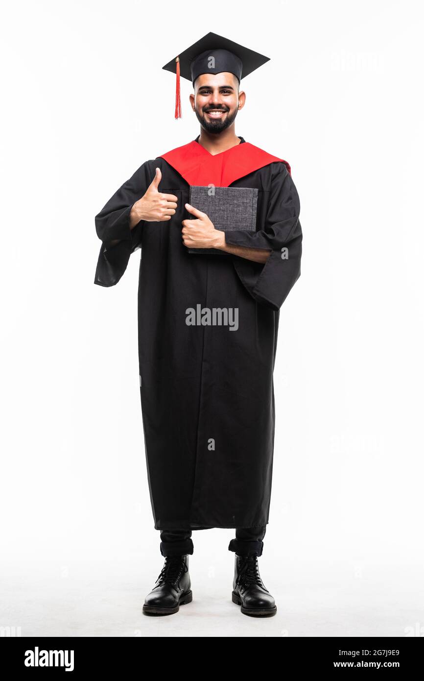 Asian Graduate man in cap and gown smile Celebrating showing thumbs up ...