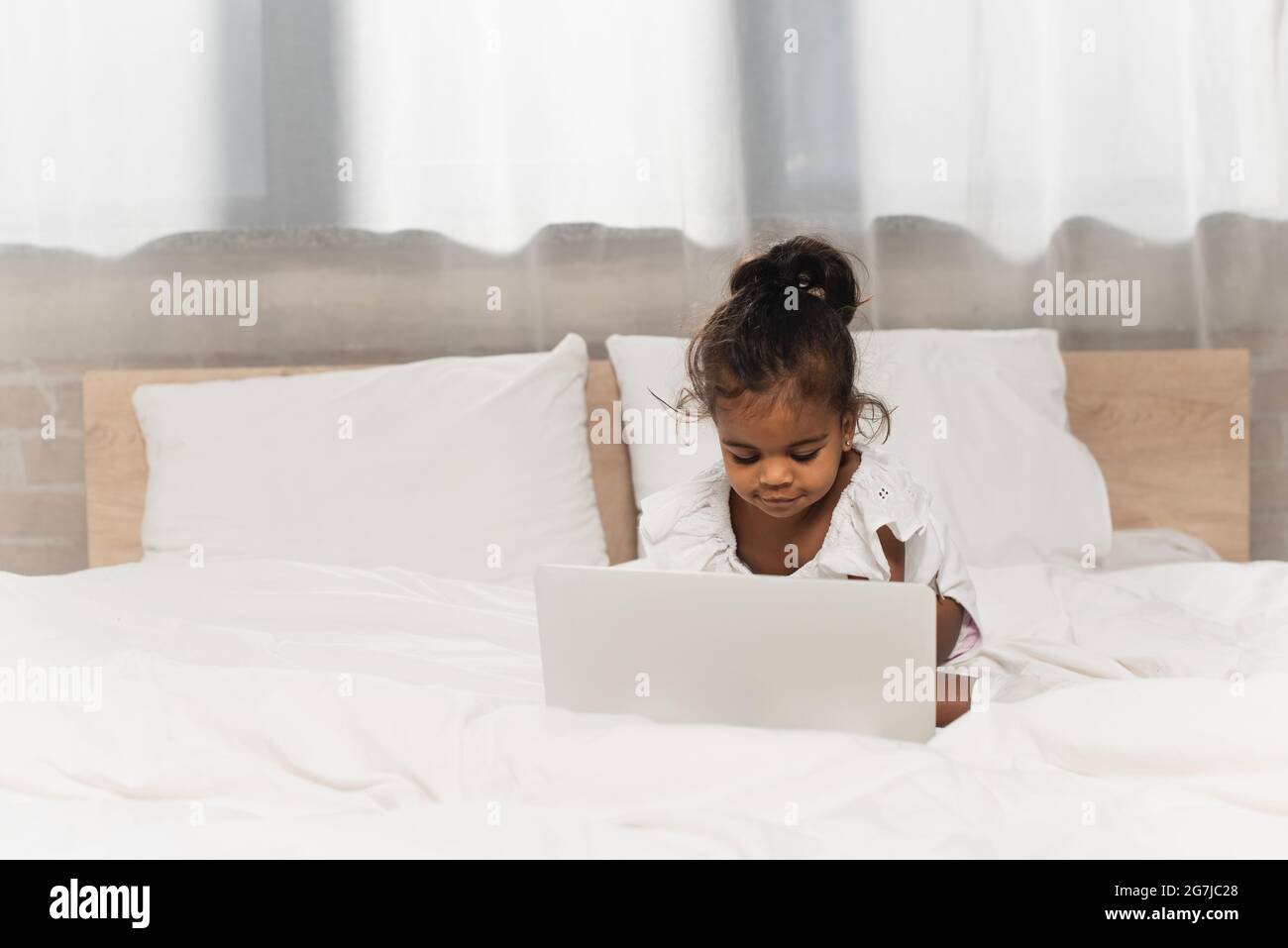 happy african american toddler kid using laptop in bedroom Stock Photo ...