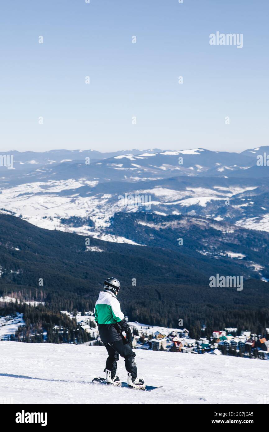 man snowboarder at the top of the slope. beautiful winter mountains ...