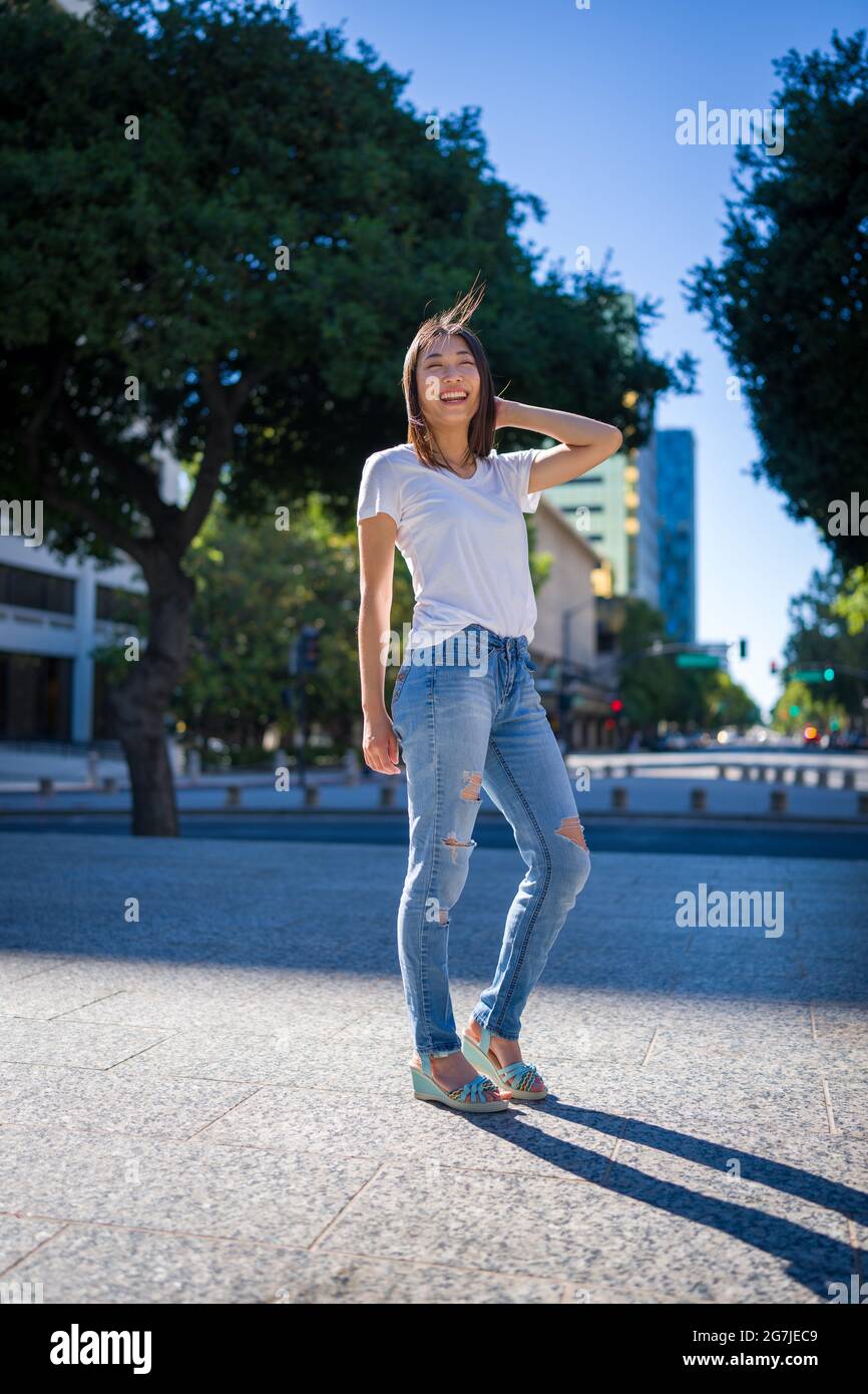 Woman in Downtown Plaza Surrounded by Tall Buildings Stock Photo - Alamy