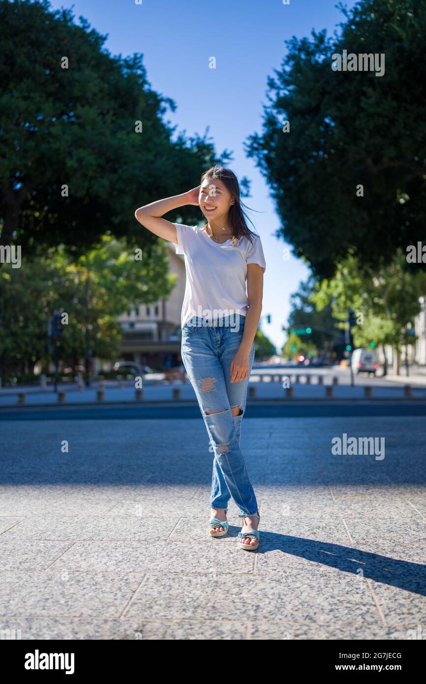 Woman in Downtown Plaza Surrounded by Tall Buildings Stock Photo - Alamy