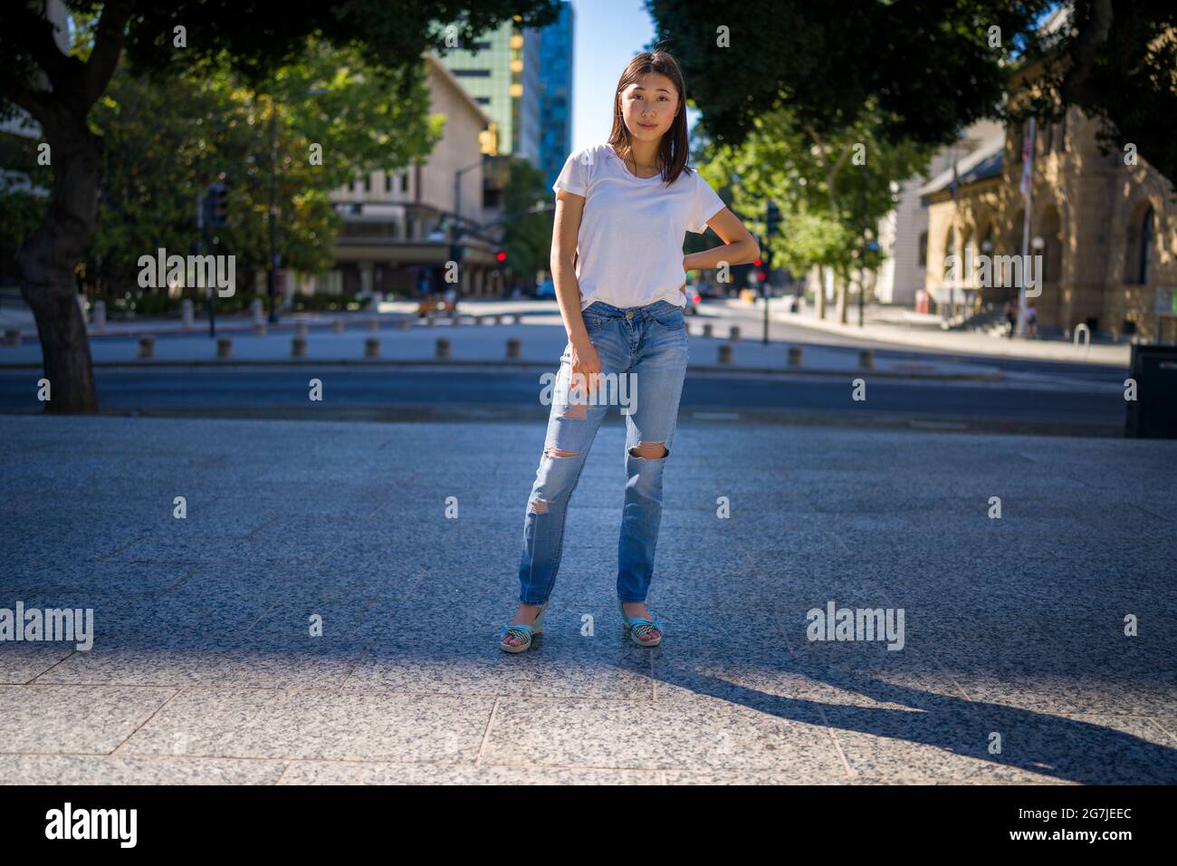 Woman in Downtown Plaza Surrounded by Tall Buildings Stock Photo - Alamy