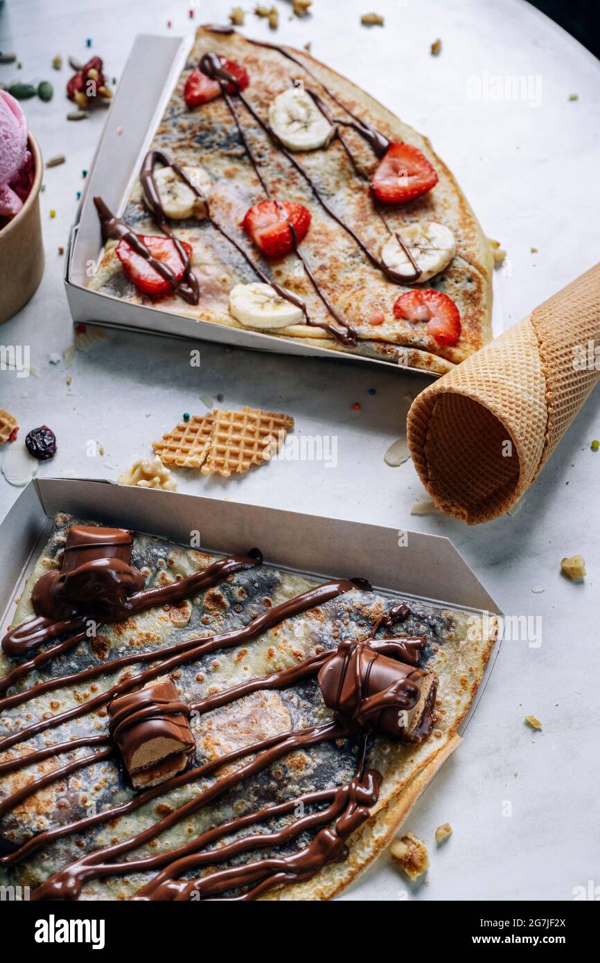 Sweet chocolate crepes on the table. Vertical picture Stock Photo - Alamy
