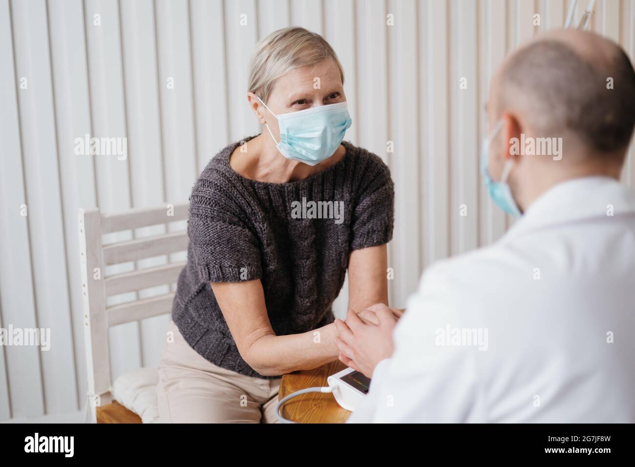 doctor calms the agitated patient during the visit Stock Photo - Alamy