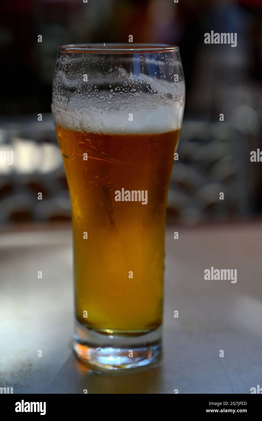 A glass of beer in a bar Stock Photo - Alamy