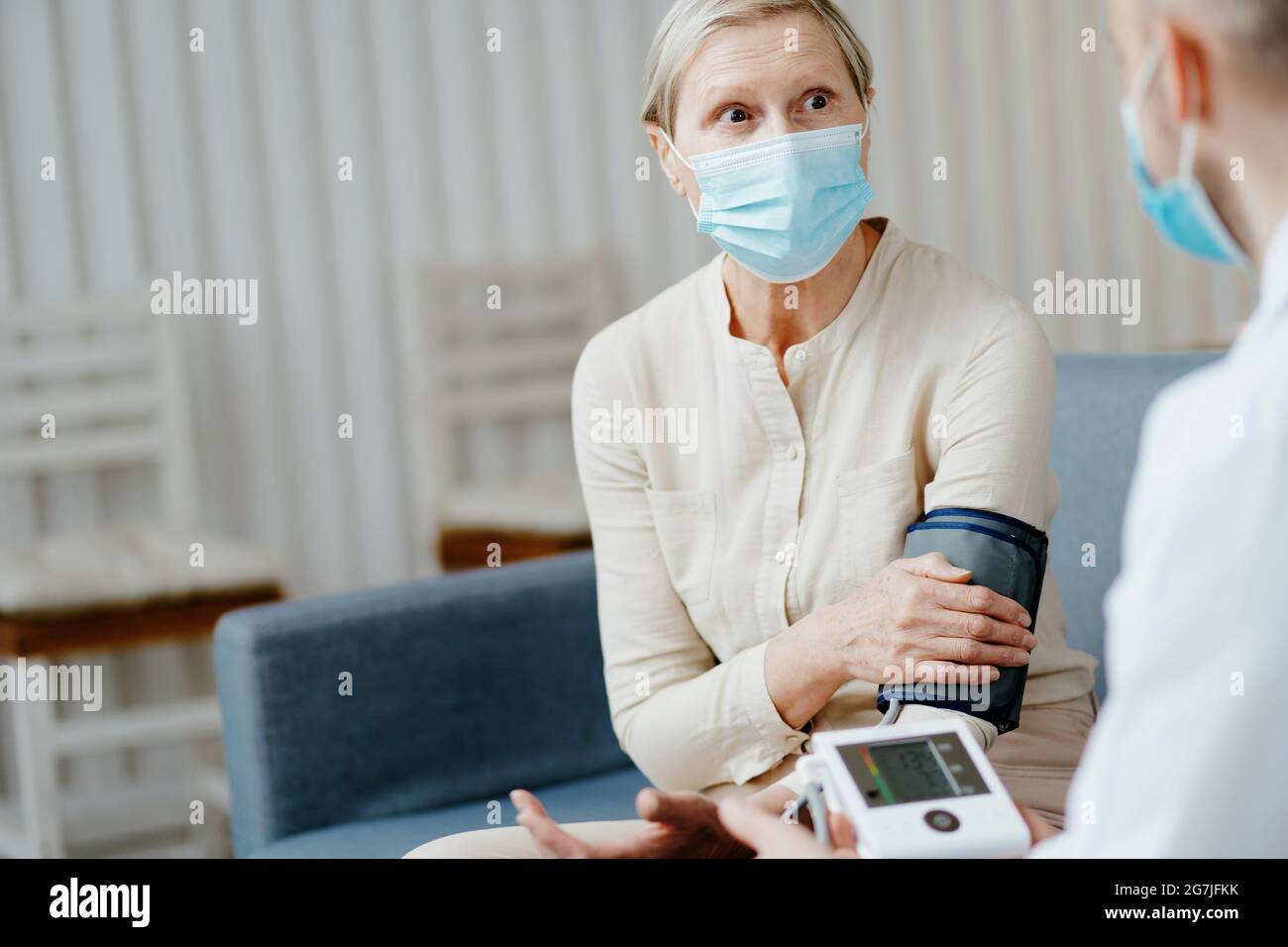 doctor measuring the pressure of a mature lady Stock Photo - Alamy