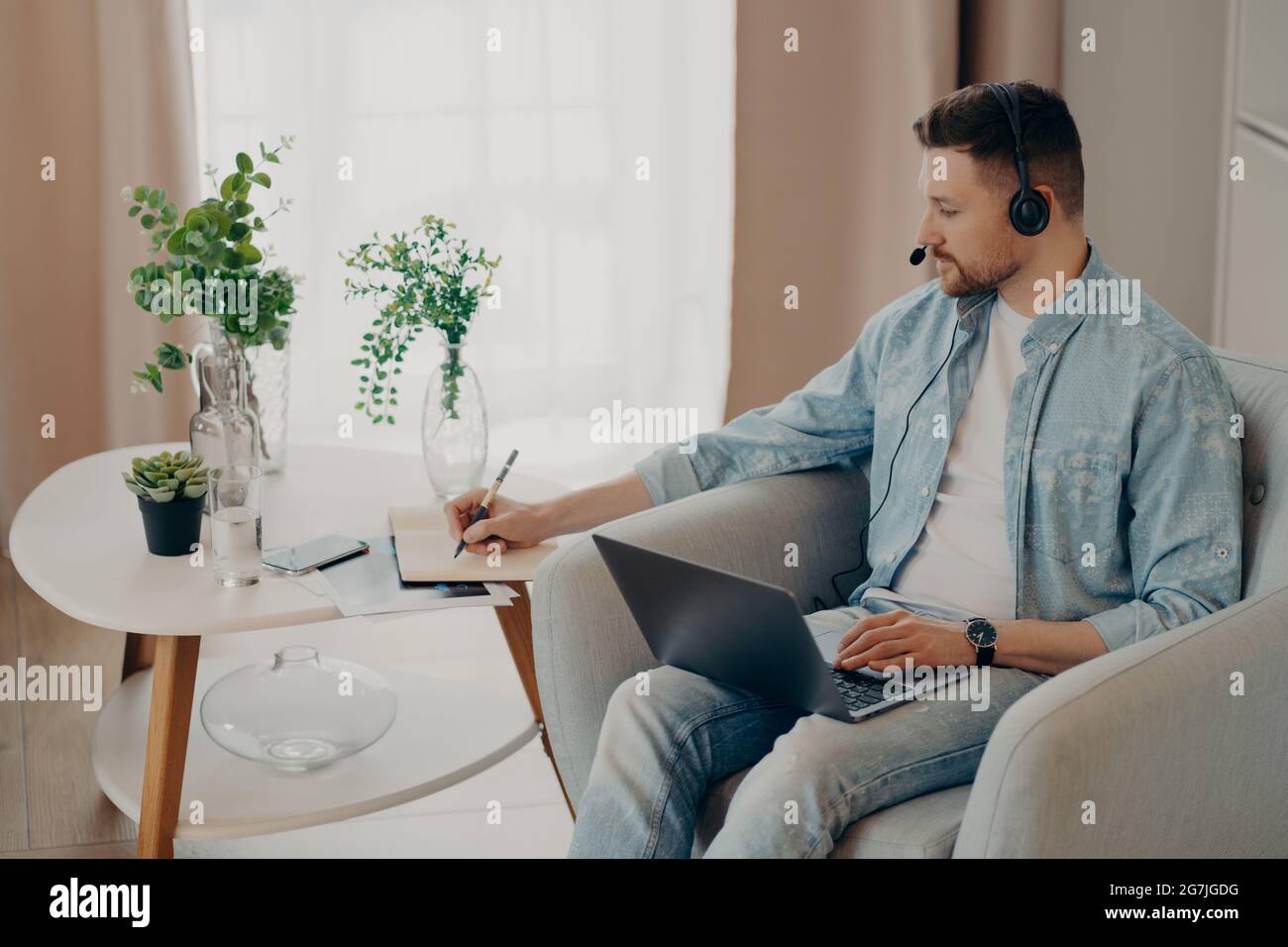 Attentive guy making notes hi-res stock photography and images - Alamy