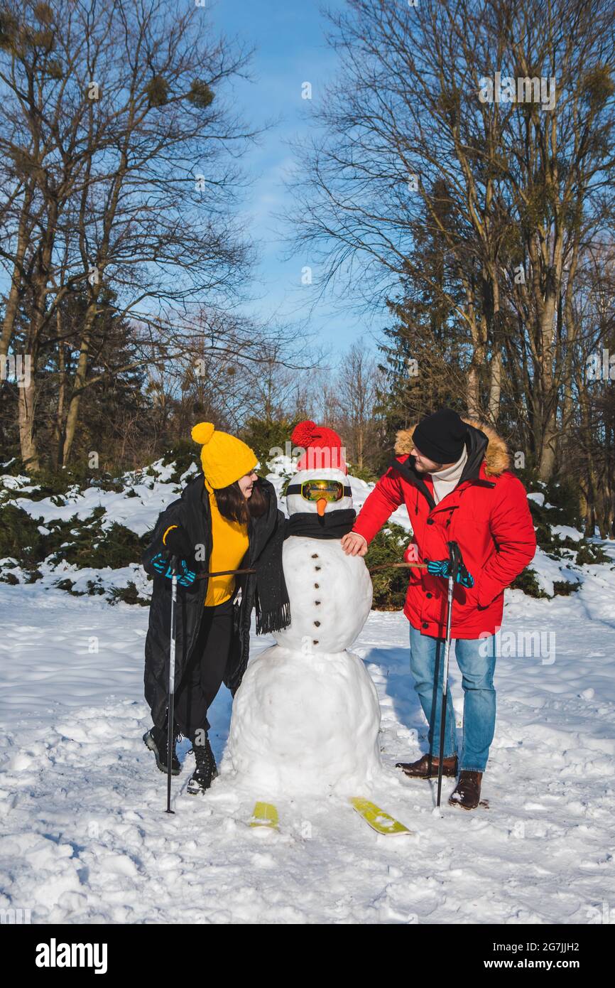 man and woman new skier snowman winter activities Stock Photo - Alamy