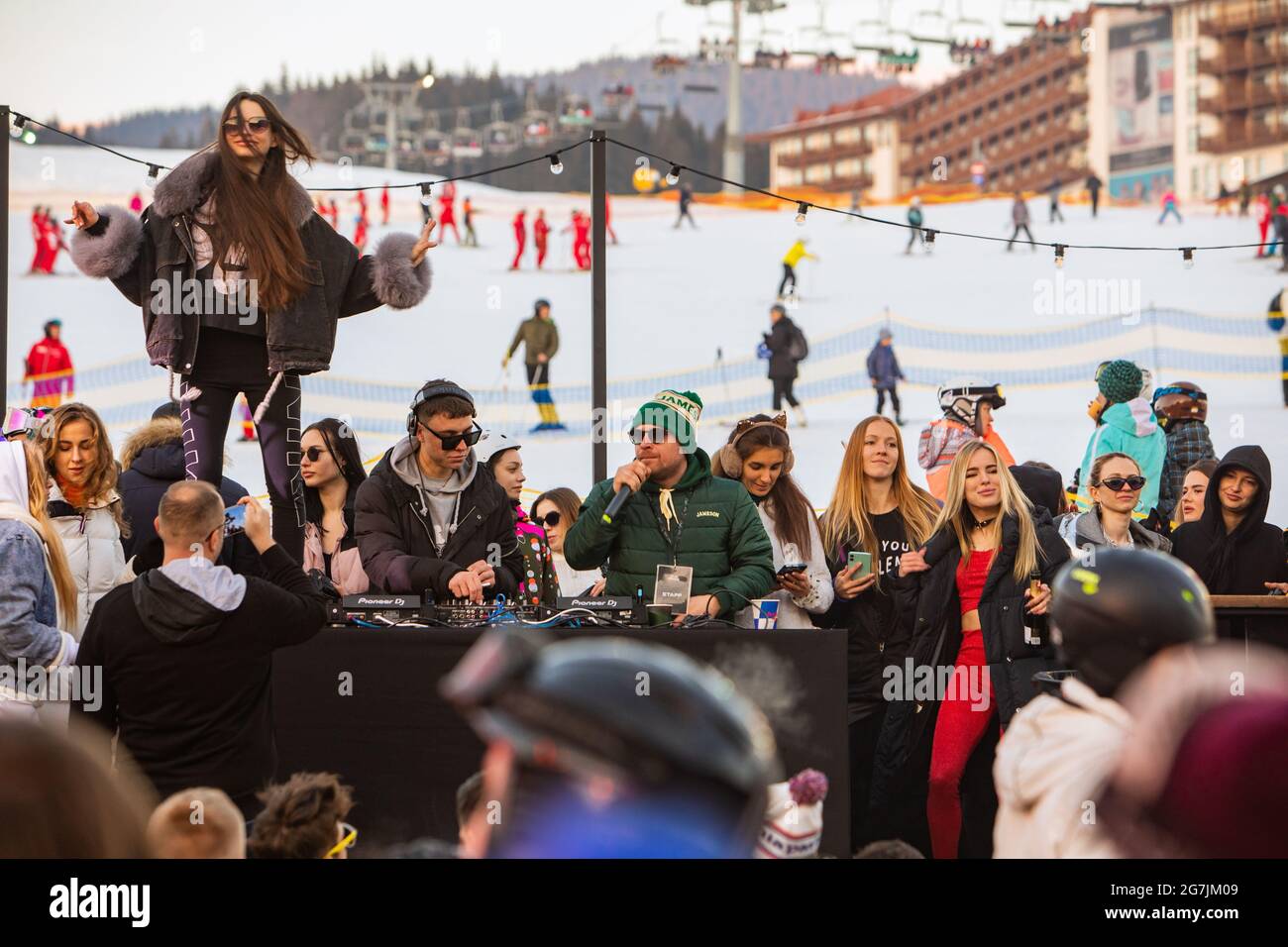 people dancing at the party after snowboarding day. ski resort. winter ...