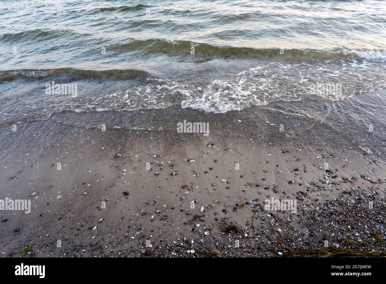Low tide waves ending at the beach Stock Photo - Alamy