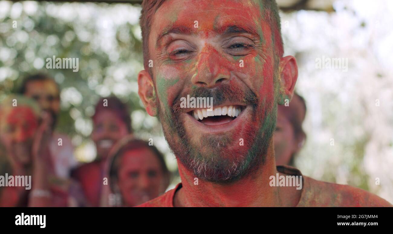 Closeup of a young happy Spanish male with a colored face celebrating ...