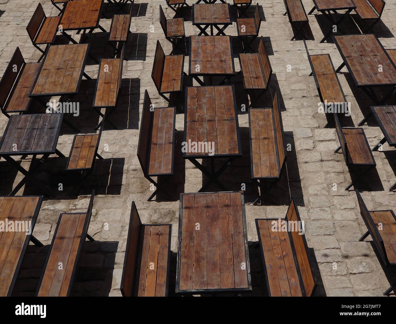 Closeup shot of an outdoor restaurant with wooden benches and table ...