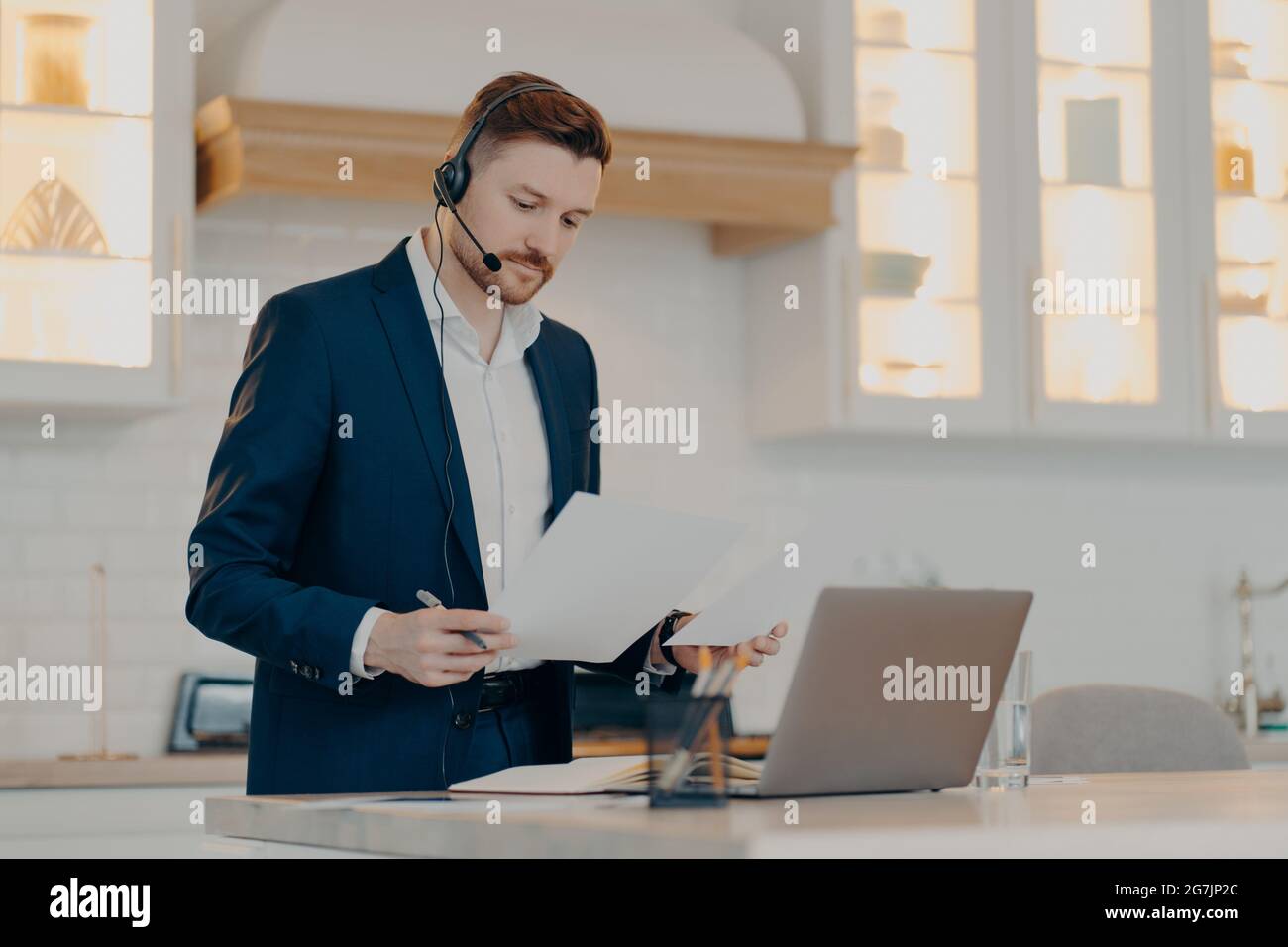 Young executive manager reviewing report while working remotely Stock ...