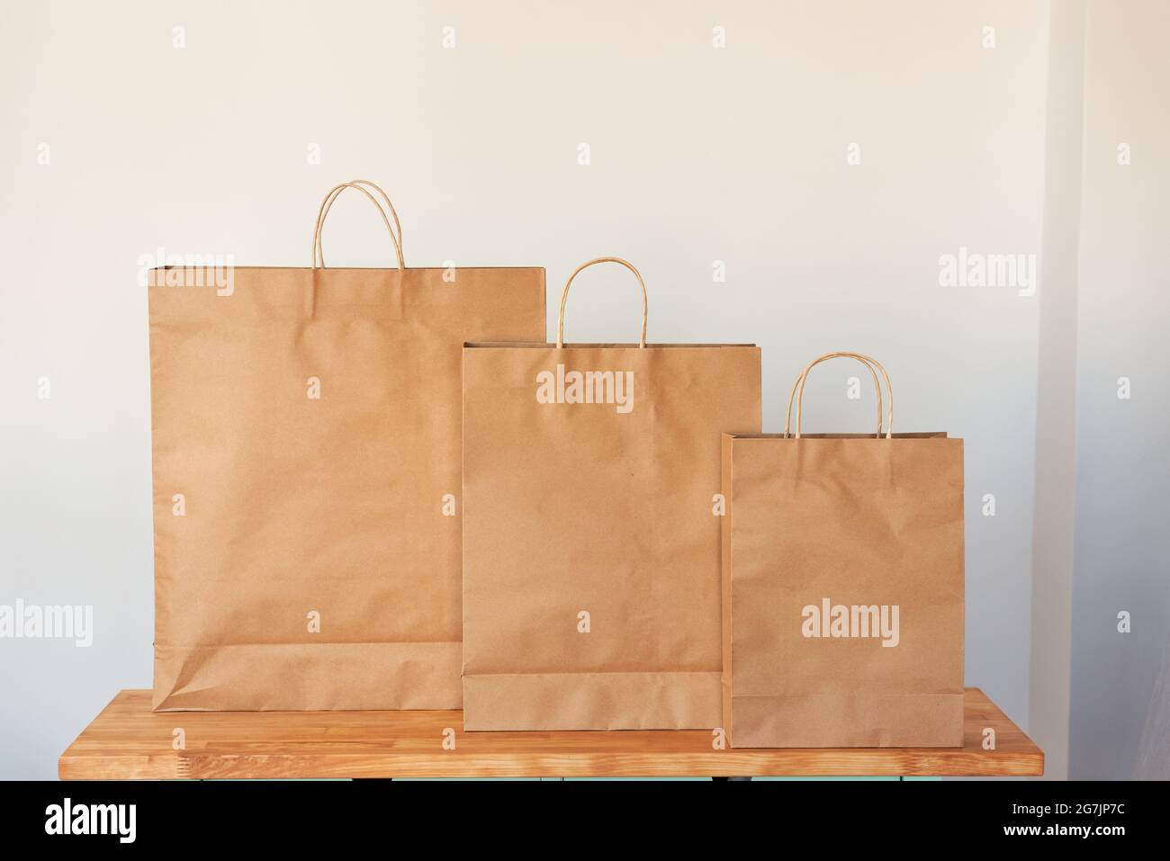 Three paper bags on isolated white background Stock Photo - Alamy