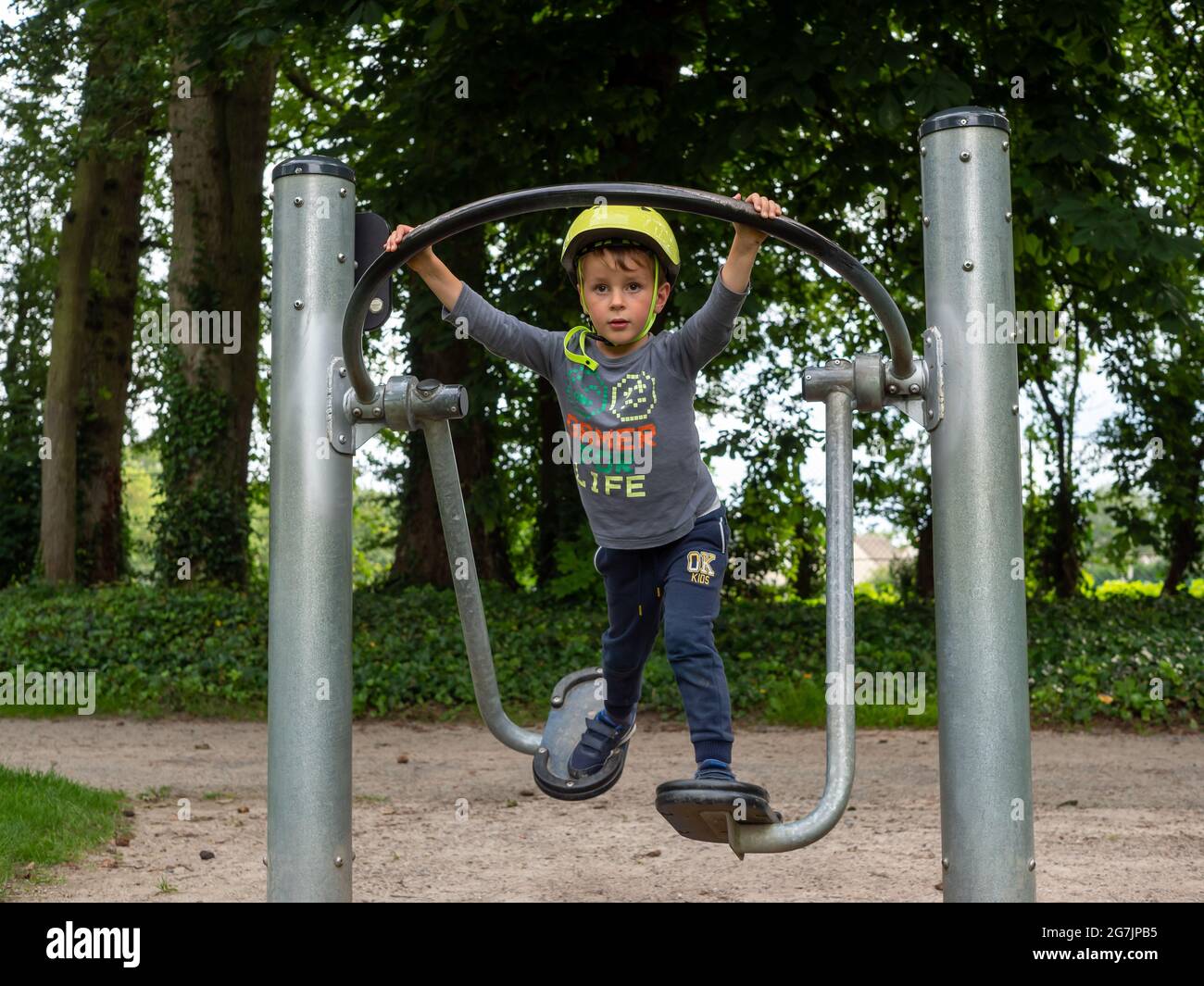Caen, France, July 2021. Child wearing a helmet playing on a stepper ...